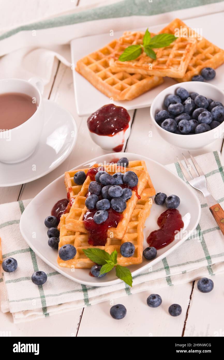 Waffles with blueberries and jam Stock Photo - Alamy