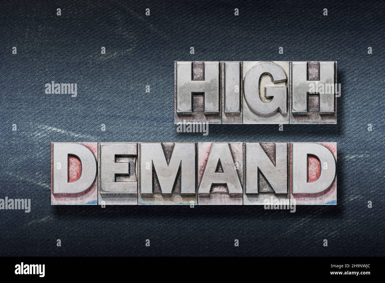 high demand phrase made from metallic letterpress on dark jeans ...