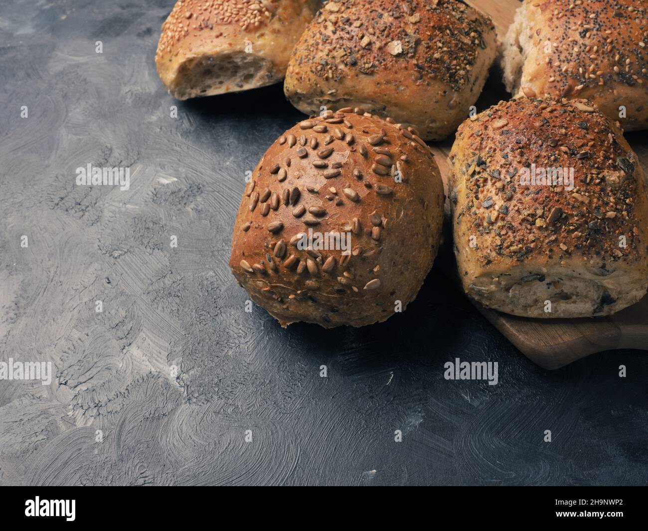 Organic whole grain rolls on a dark background with space for text ...