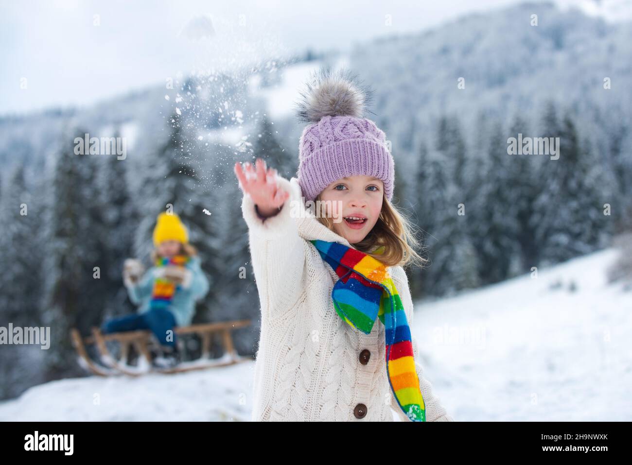 Happy kids playing snowball fight hi-res stock photography and images ...