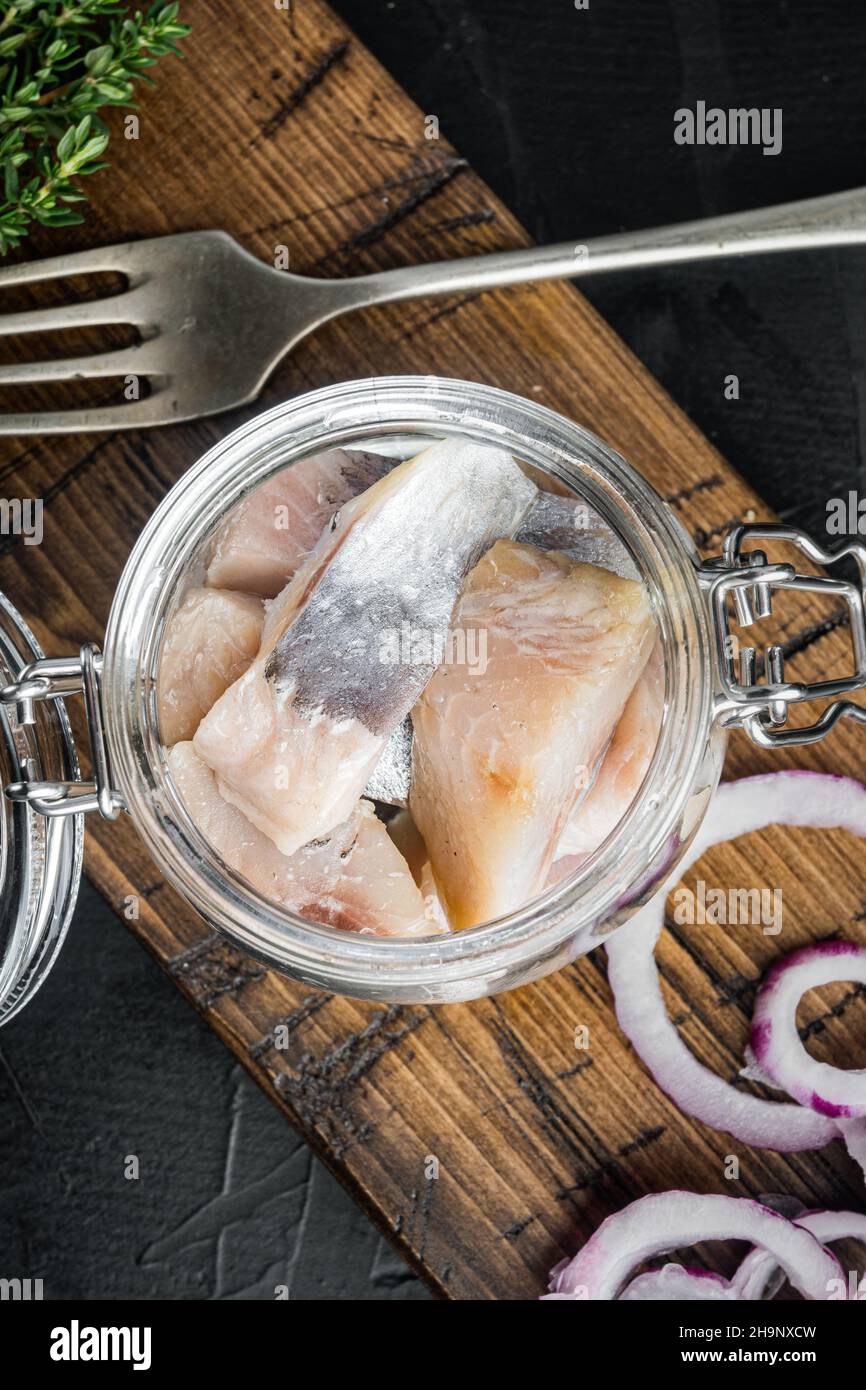 Herring fillet in oil, on black background, top view flat lay Stock ...