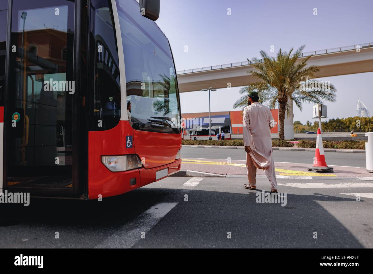 DUBAI, UAE - MARCH 15, 2021: Red urban bus is driving on a street in ...