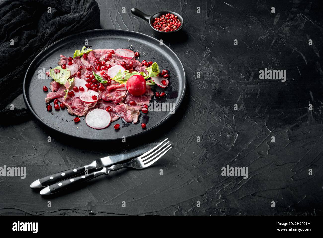 Carpaccio of marbled beef set, with Radish and garnet, on plate, on ...
