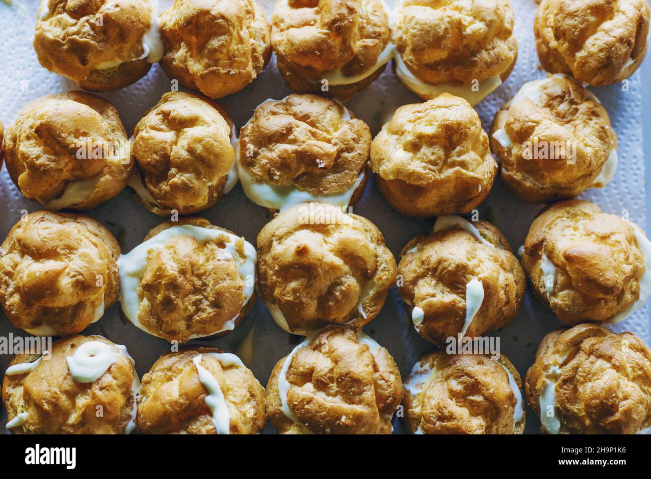 Close-up shot of iconic vanilla cream puffs in rows on a tray Stock ...