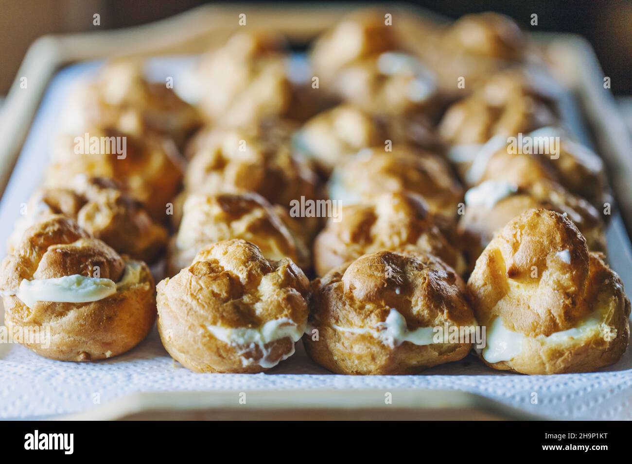 Close-up shot of iconic vanilla cream puffs in rows on a tray Stock ...