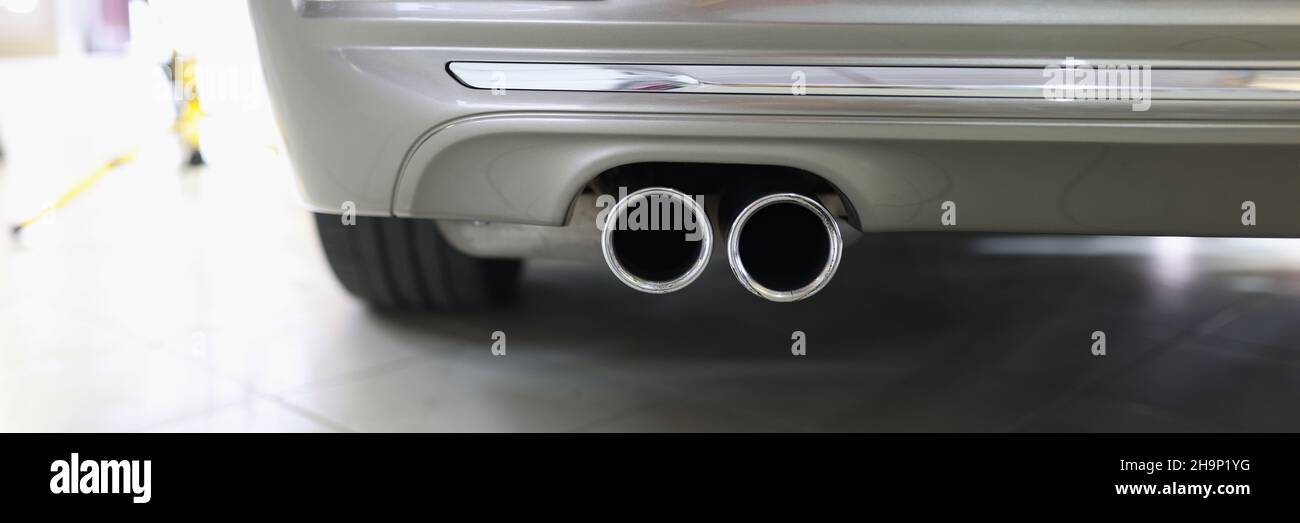 Exhaust pipe and back of new car in car service closeup Stock Photo - Alamy