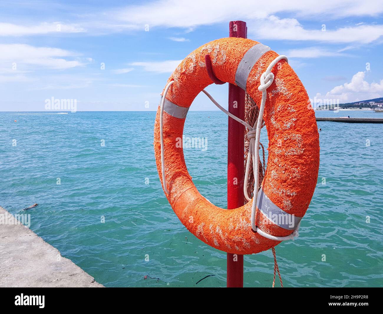 Lifebuoy close-up on the pier against the background of the sea Stock ...