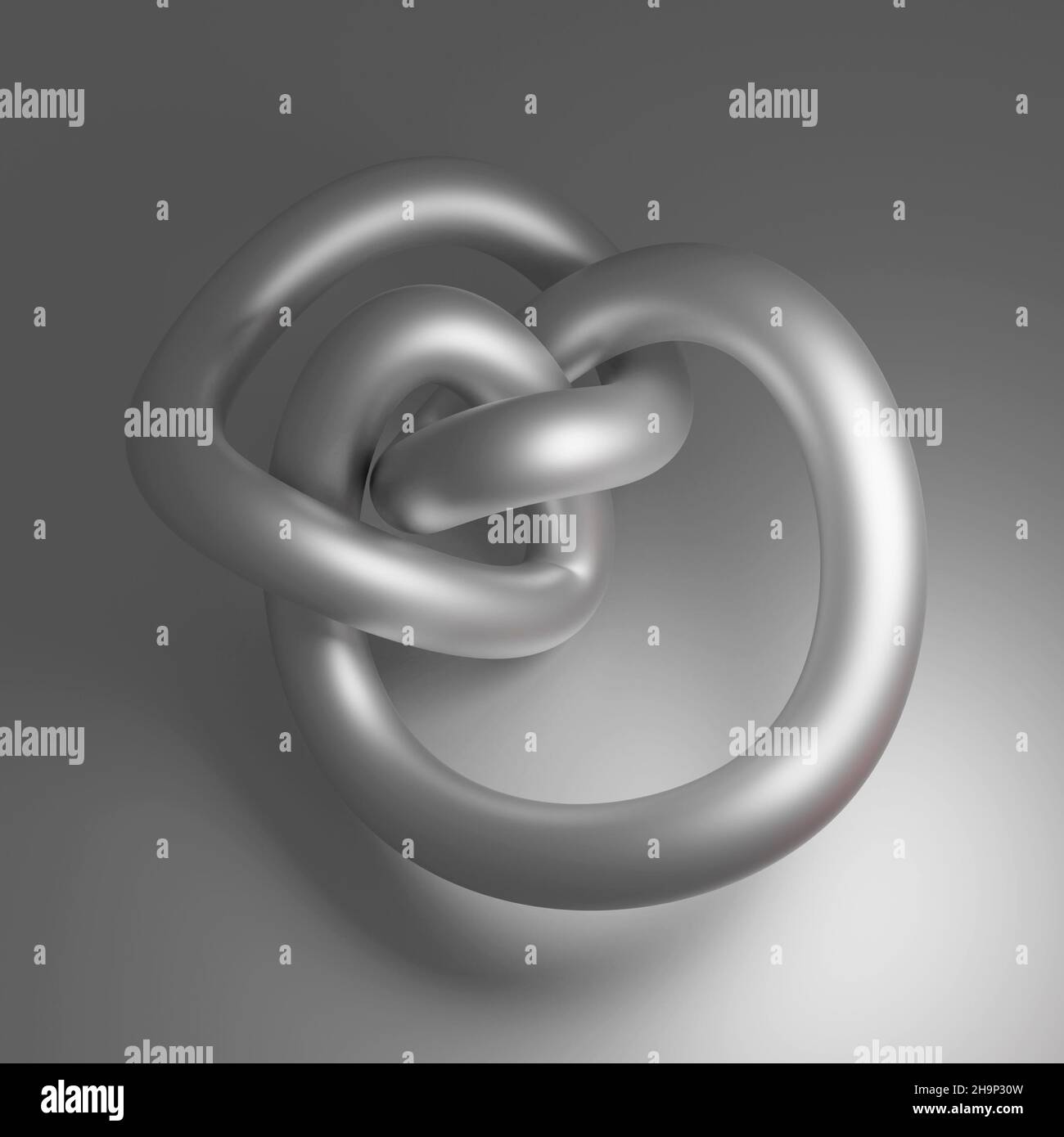 Steel wire tied in a knot on a gray background. A shiny gray torus ...