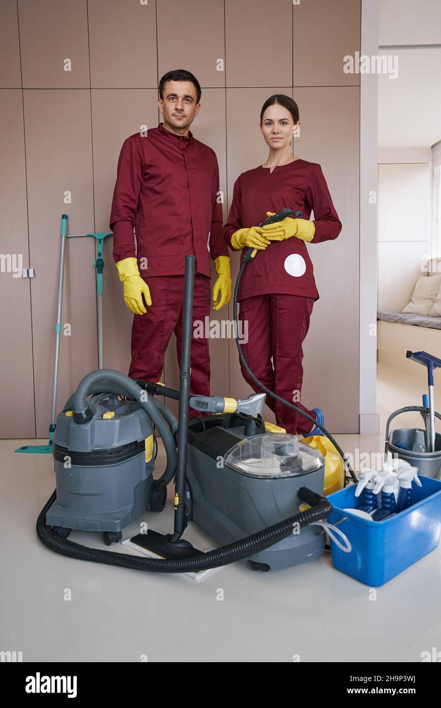 Janitorial staff posing for camera in workplace Stock Photo - Alamy