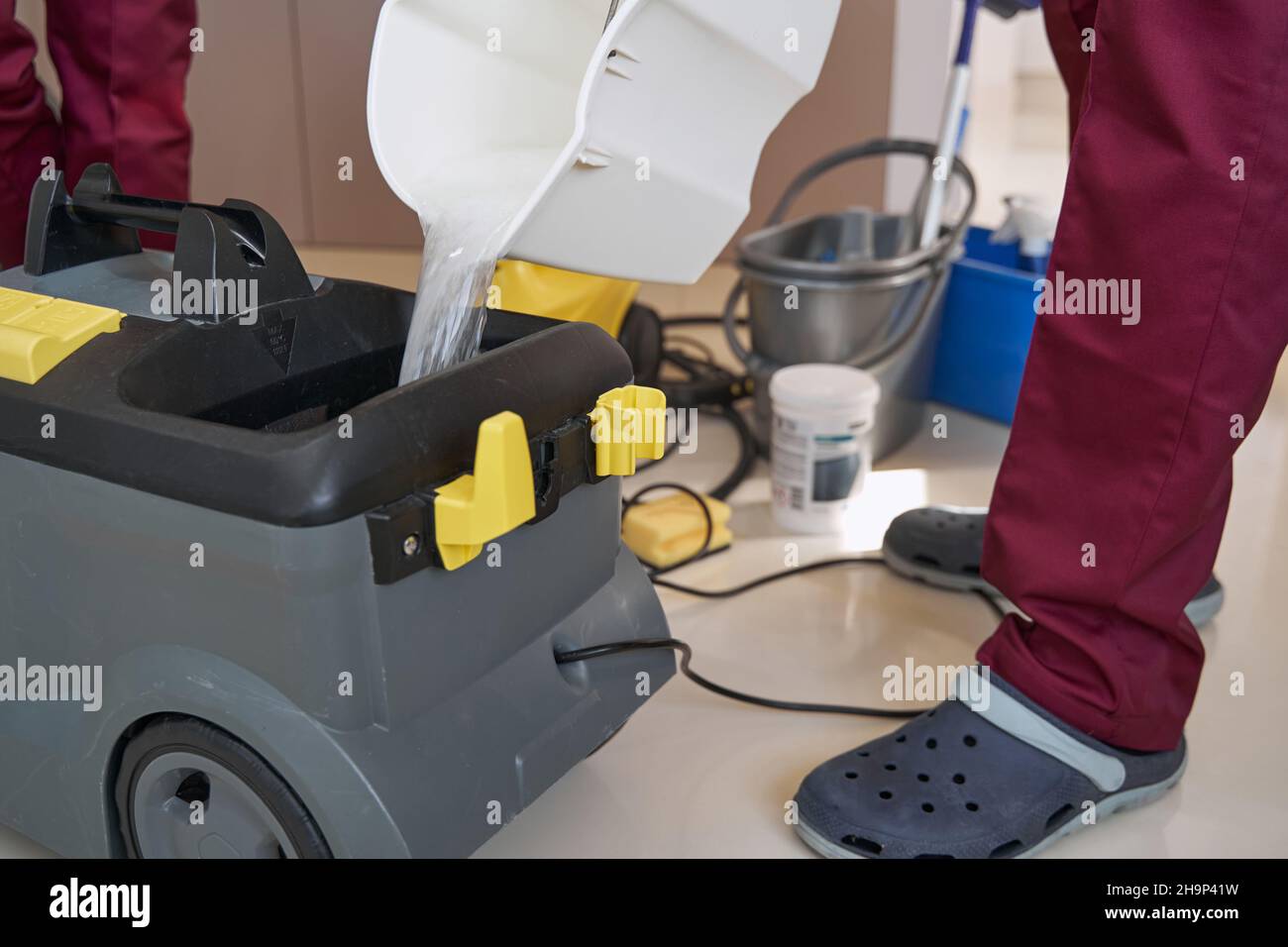Experienced cleaner preparing equipment for wet cleaning Stock Photo ...