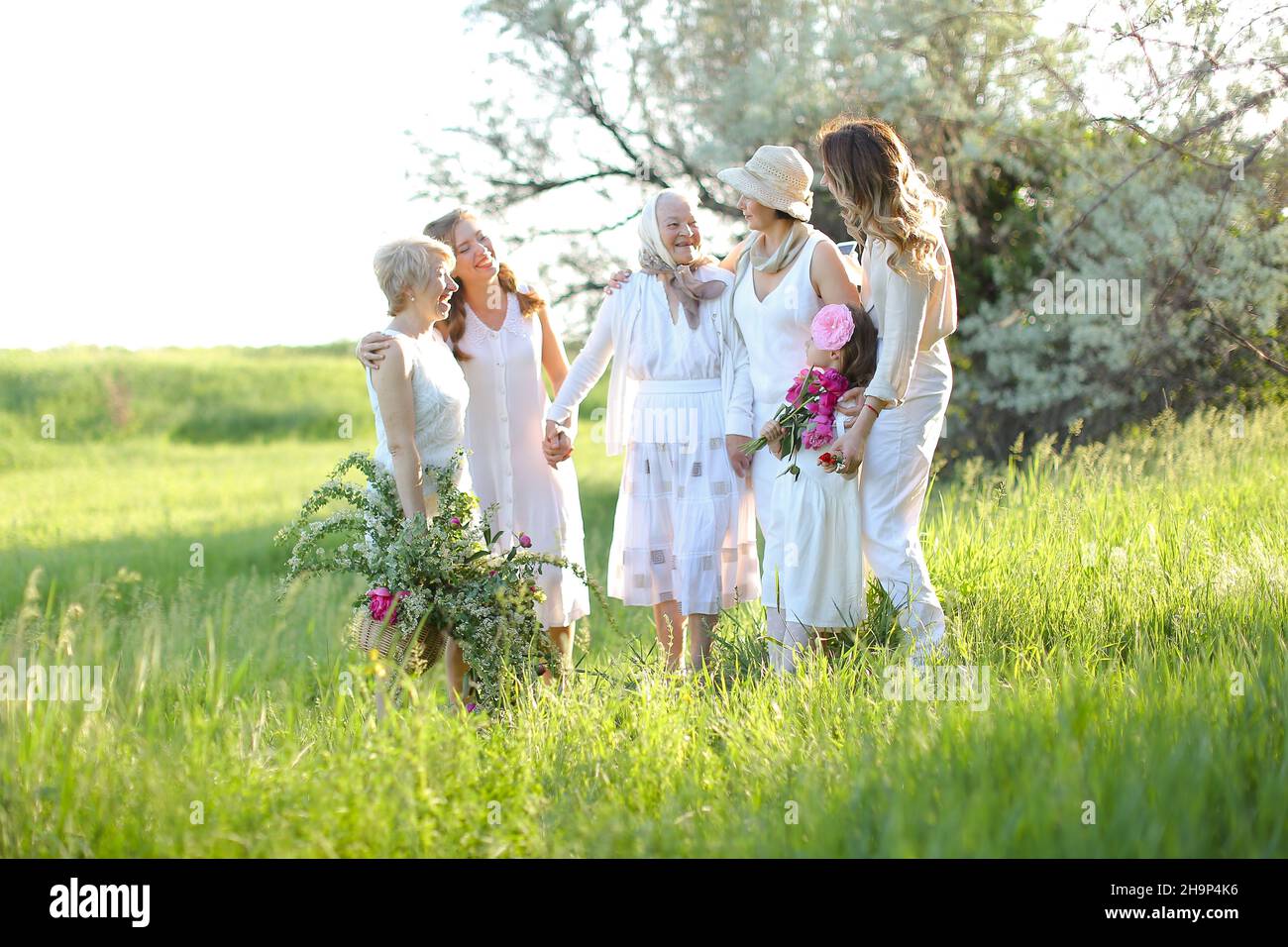 European old granny standing with daughters, granddaughters and grand ...