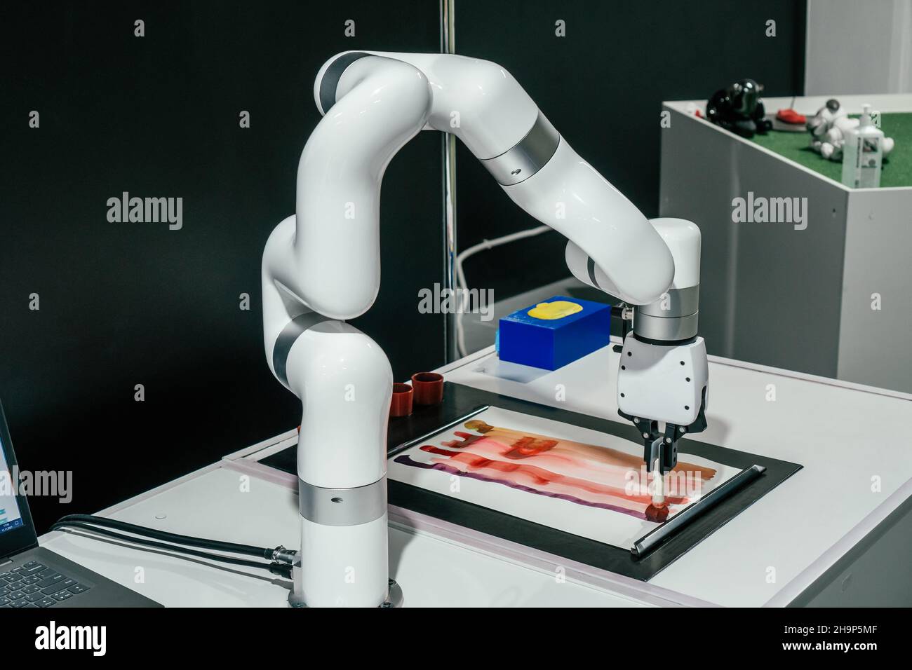 Partially blurred robot with automatic gripping claws and many joints ...