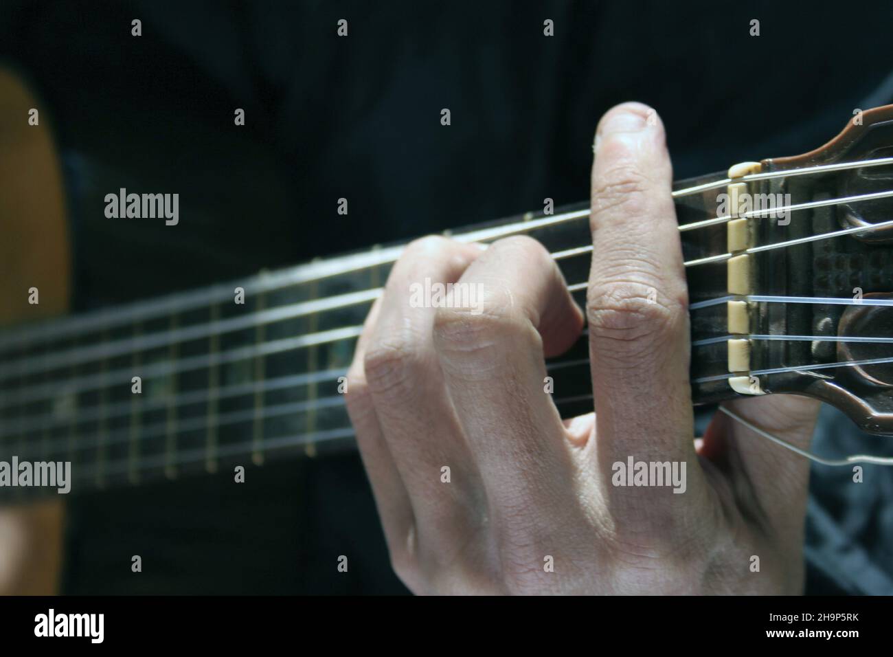 Closeup shot of fingers playing on the guitar Stock Photo - Alamy