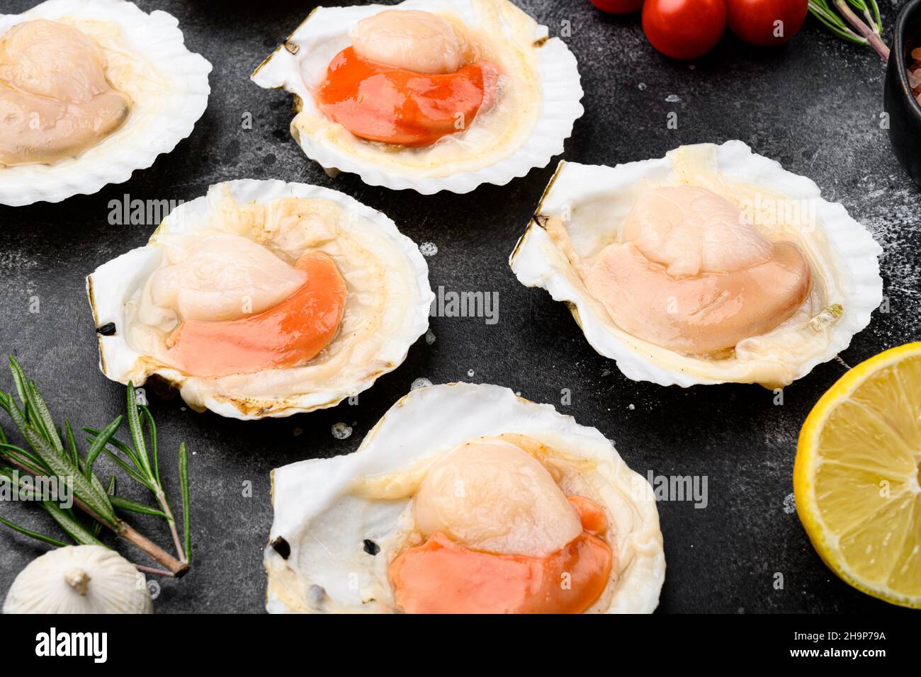 Fresh scallop set, on black dark stone table background Stock Photo - Alamy
