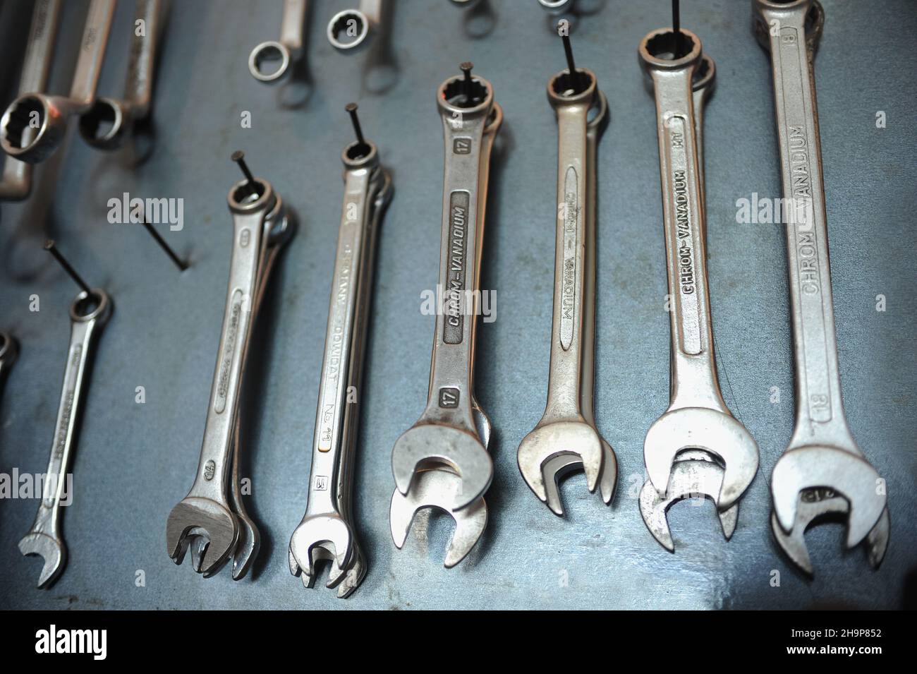 Spanners on the wall of auto mechanics workshop Stock Photo - Alamy