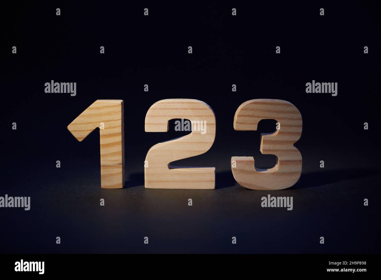wooden numbers 123 on a black background Stock Photo - Alamy