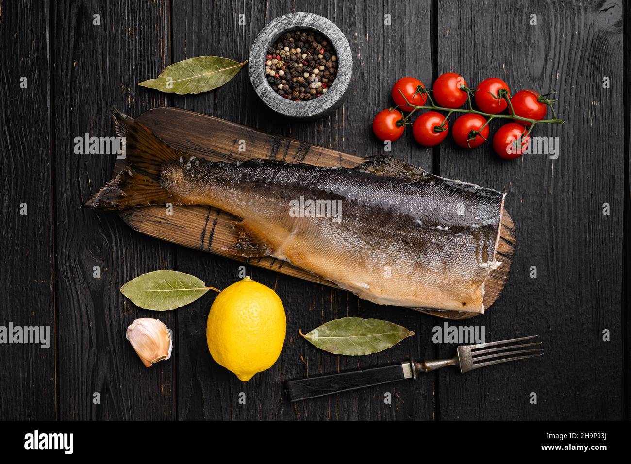 Whole smoked trout fish set, on black wooden table background, top view ...