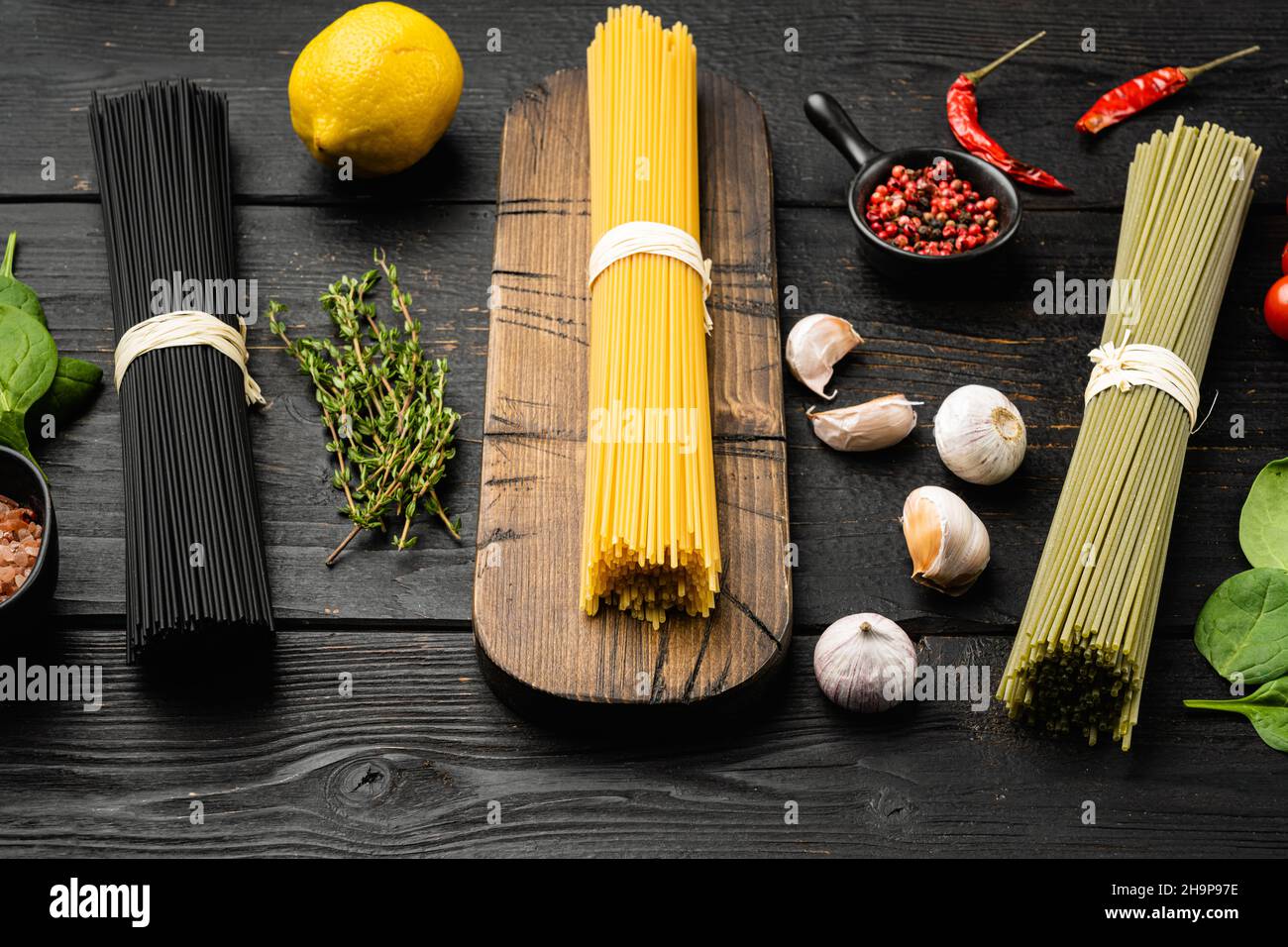 Colored spaghetti raw dry set, on black wooden table background Stock ...