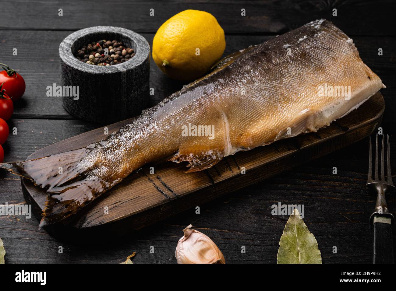 Cold smoked fish trout or salmon set, on black wooden table background ...