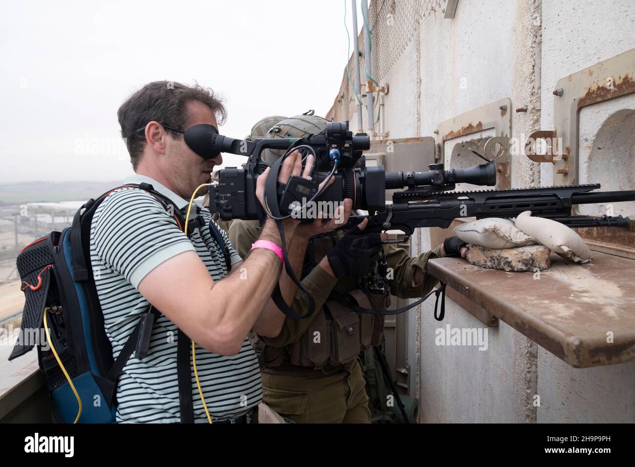 Gaza Border, Israel. 7th Dec, 2021. A TV news cameraman filming snipers ...