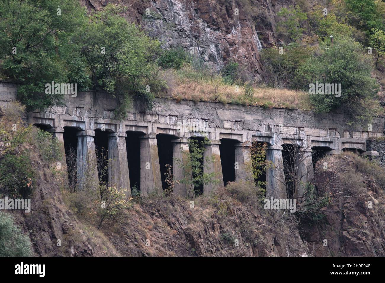 A concrete bridge supporting railway passage through steep and abrupt ...