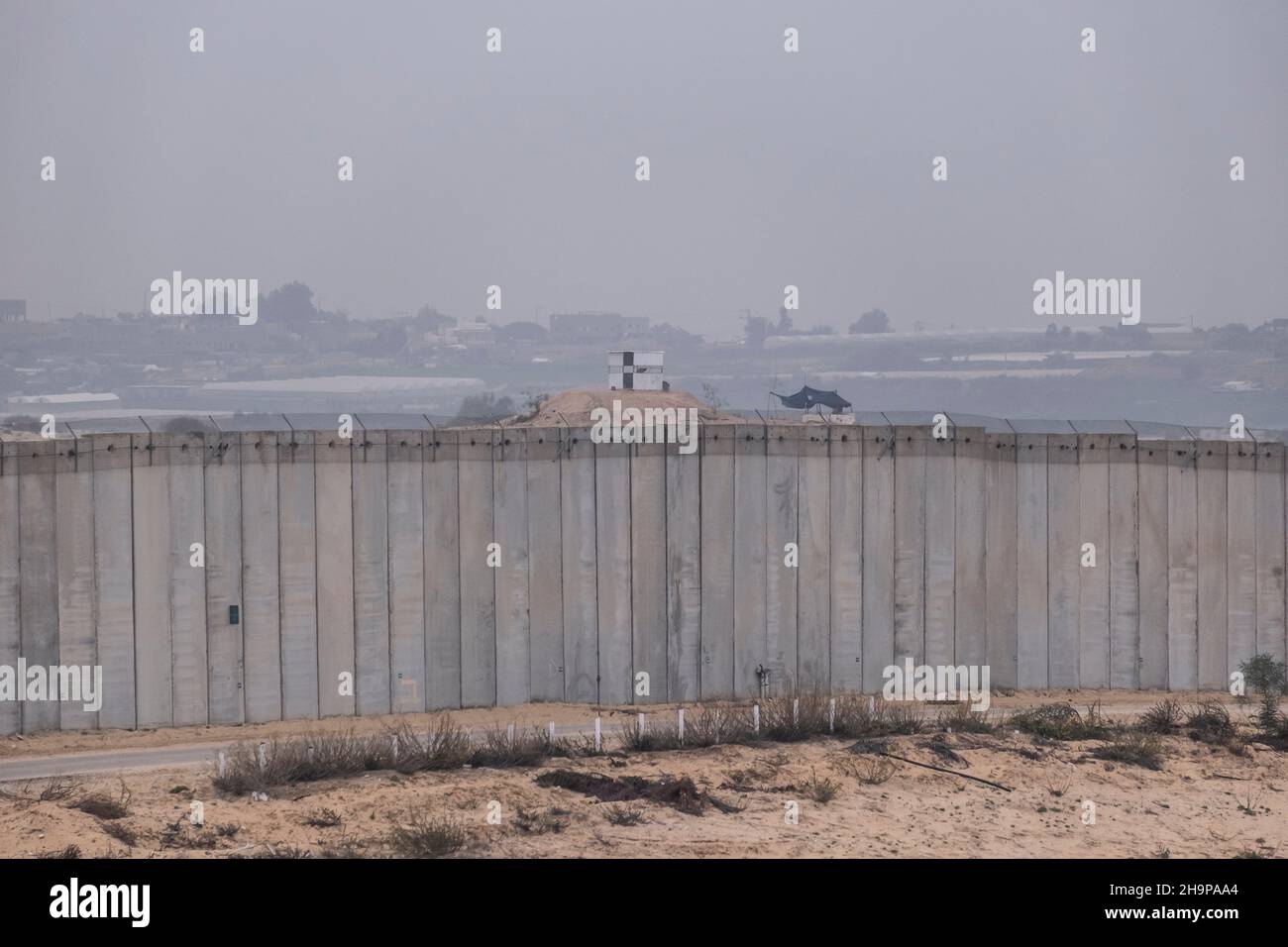 View of a Palestinian military watch tower across a concrete wall at ...