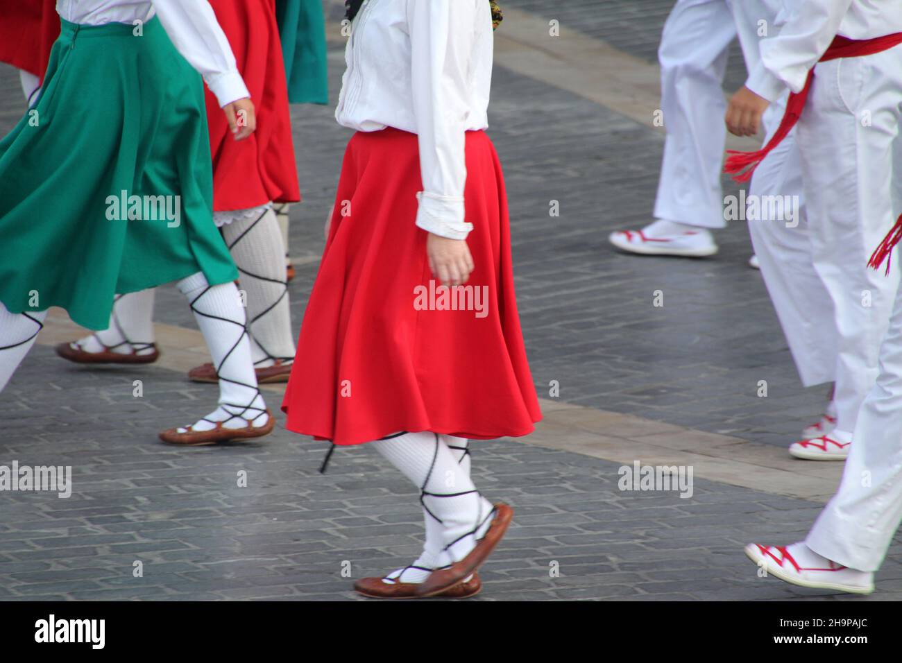 Group of people in traditional clothing doing a folk dance in Basque ...