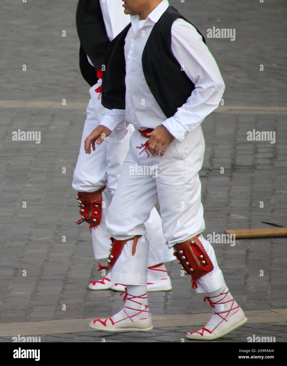 Vertical shot of a person in traditional clothing doing a folk dance in ...