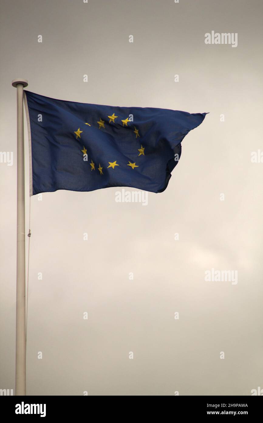 Vertical shot of a European Union flag waving on a pole Stock Photo - Alamy