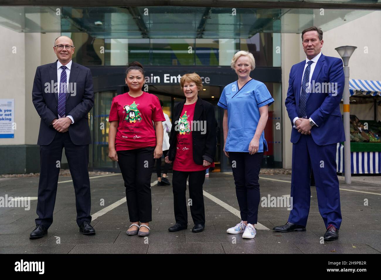 (left to right) NHSE Medical Director Stephen Powis, nurse May Parsons ...