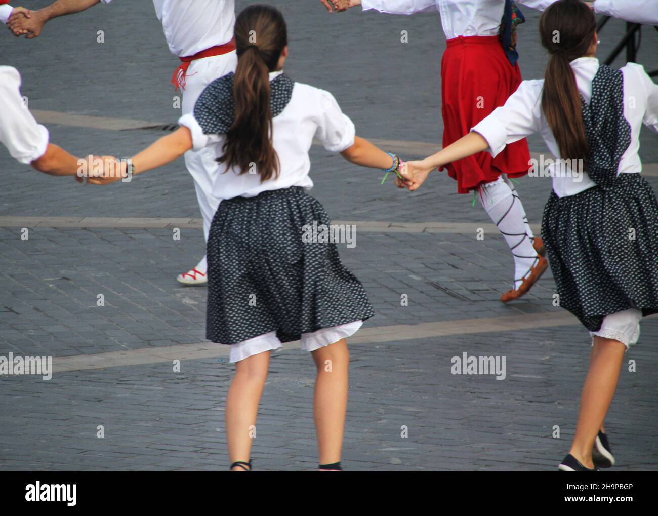View of people with traditional clothes dancing a folk dance in Basque ...