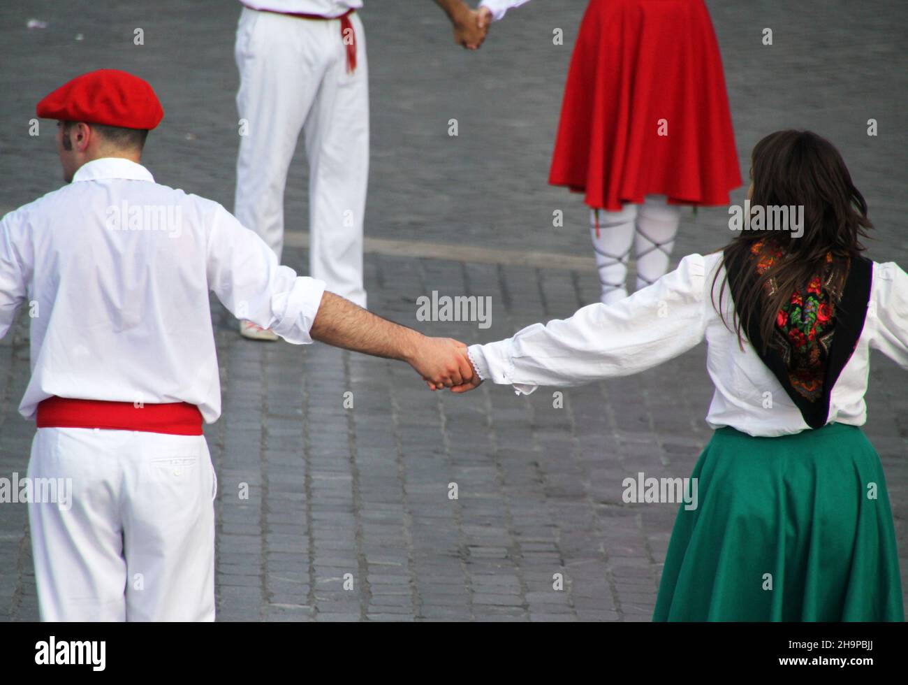 Group of people in traditional clothing doing a folk dance in Basque ...