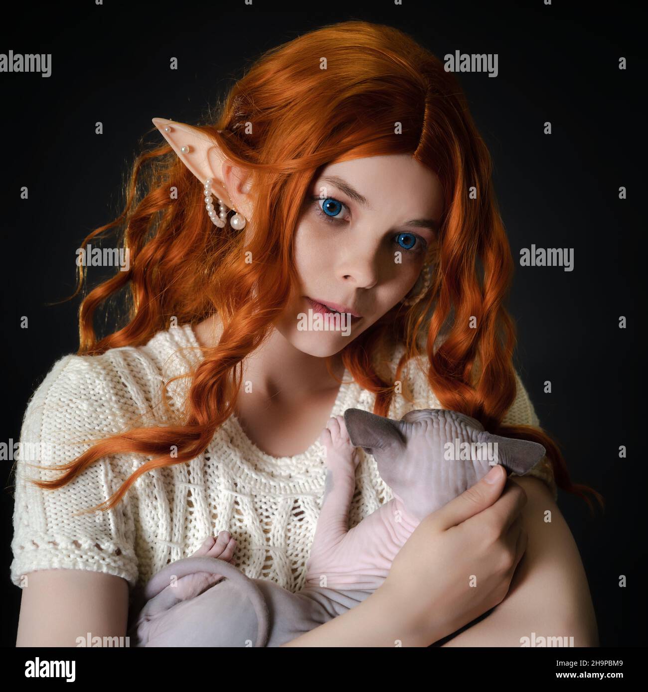 Close-up view of ginger young woman cosplayer elf in white knitted ...