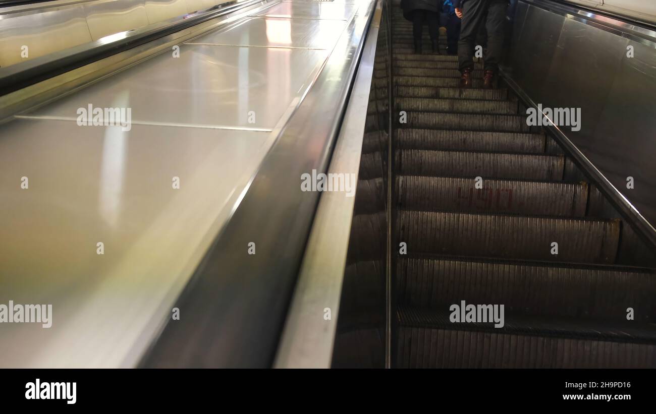 Close-up of people going down to the subway or underground train ...