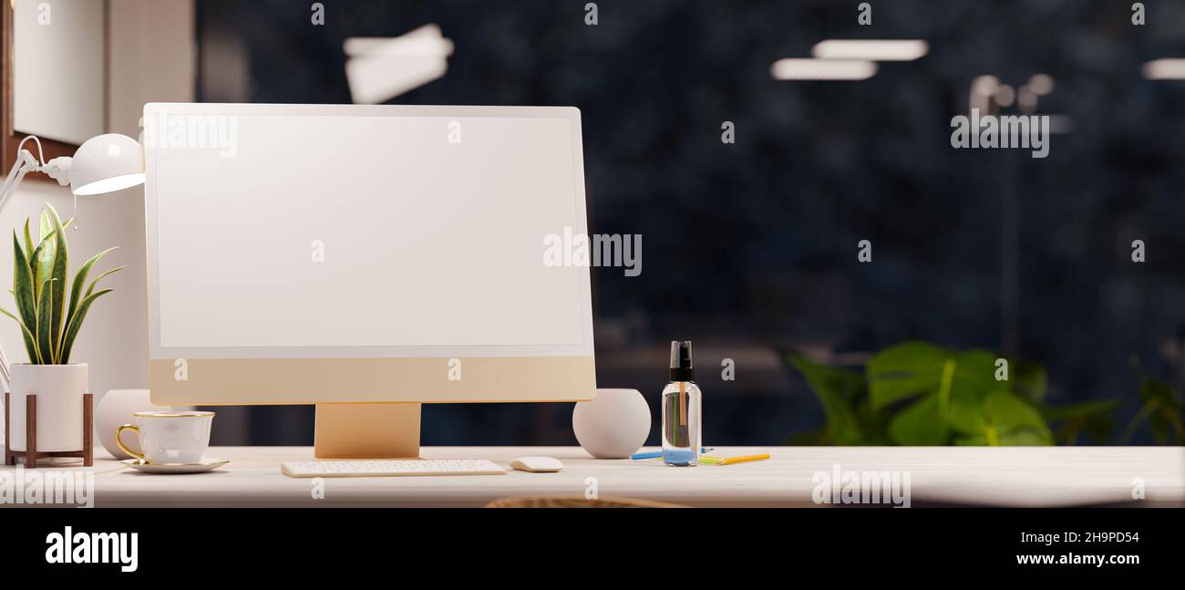 Close-up computer desk with white monitor on modern desk and city night ...