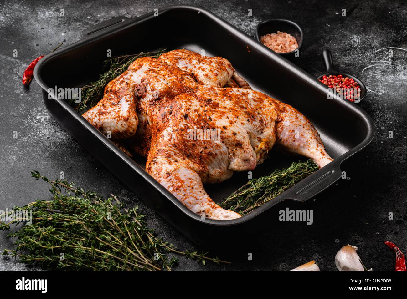 Raw marinated chicken prepared in Asian style set, on black dark stone ...