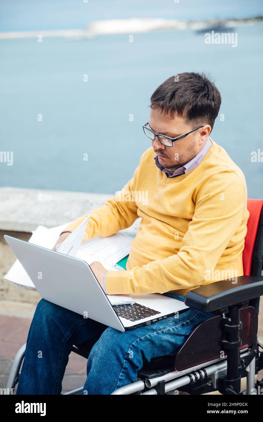 a man with a disability in a disabled working business remotely Stock ...
