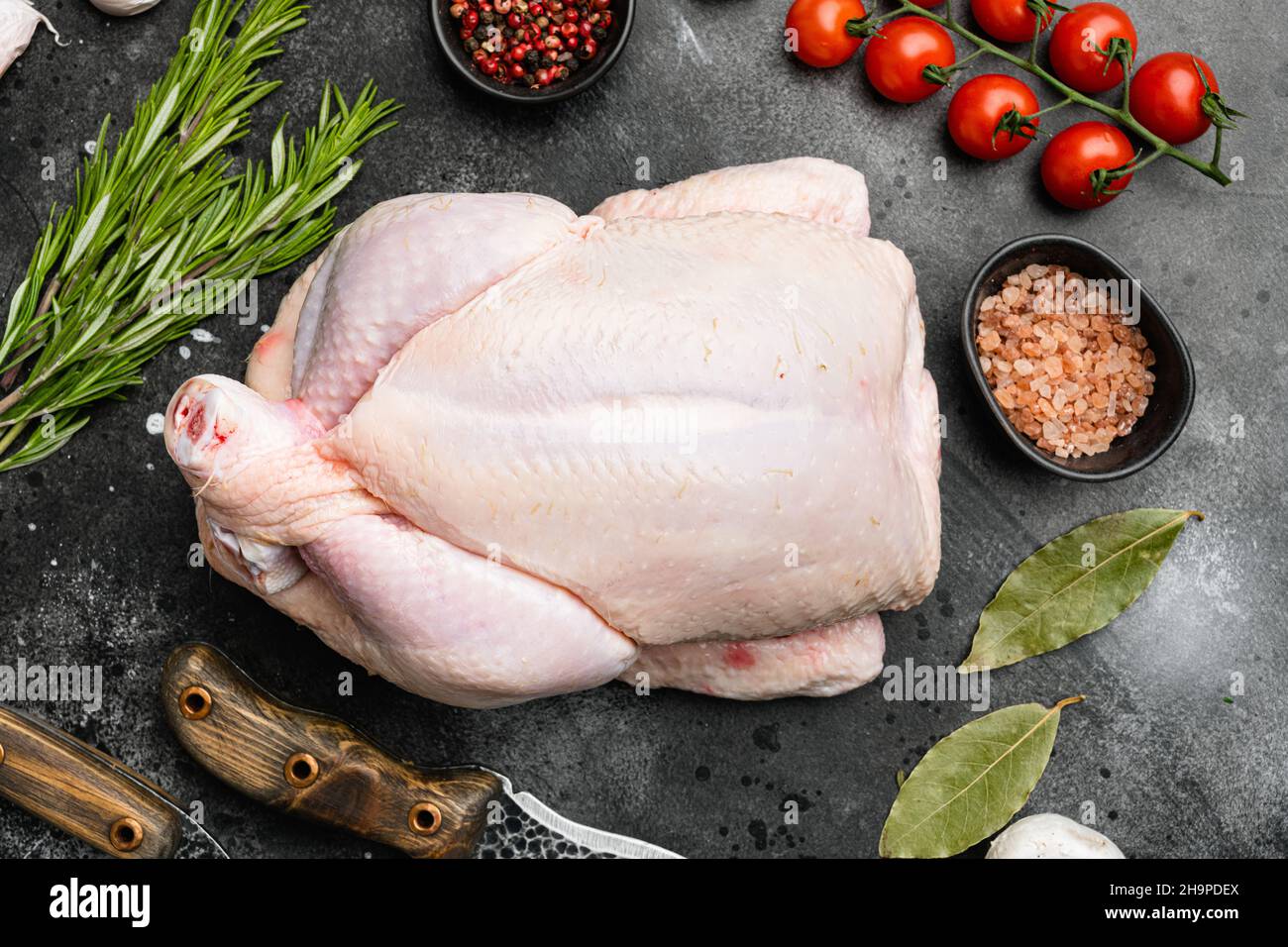 Organic raw whole chicken set, on black dark stone table background ...