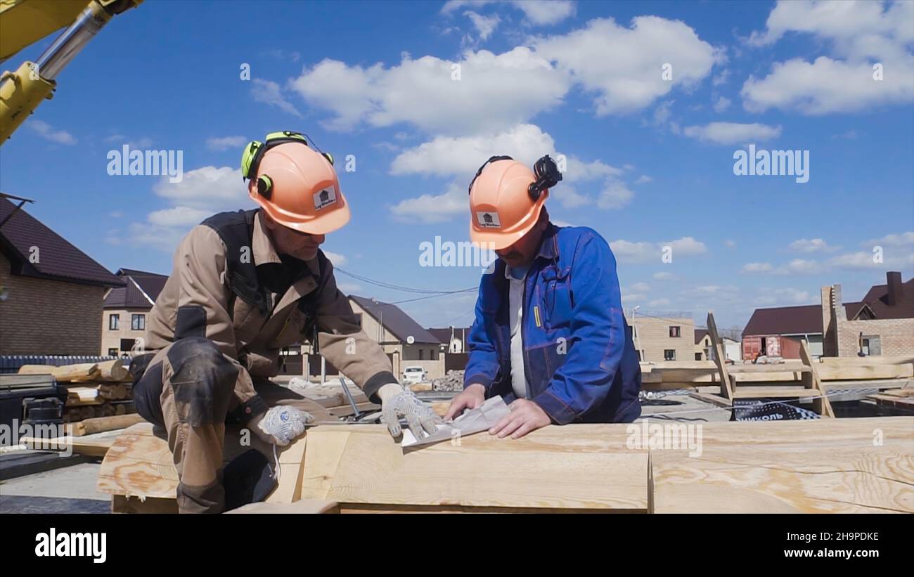 Construction workers in construction site safety uniform. Clip. Two ...