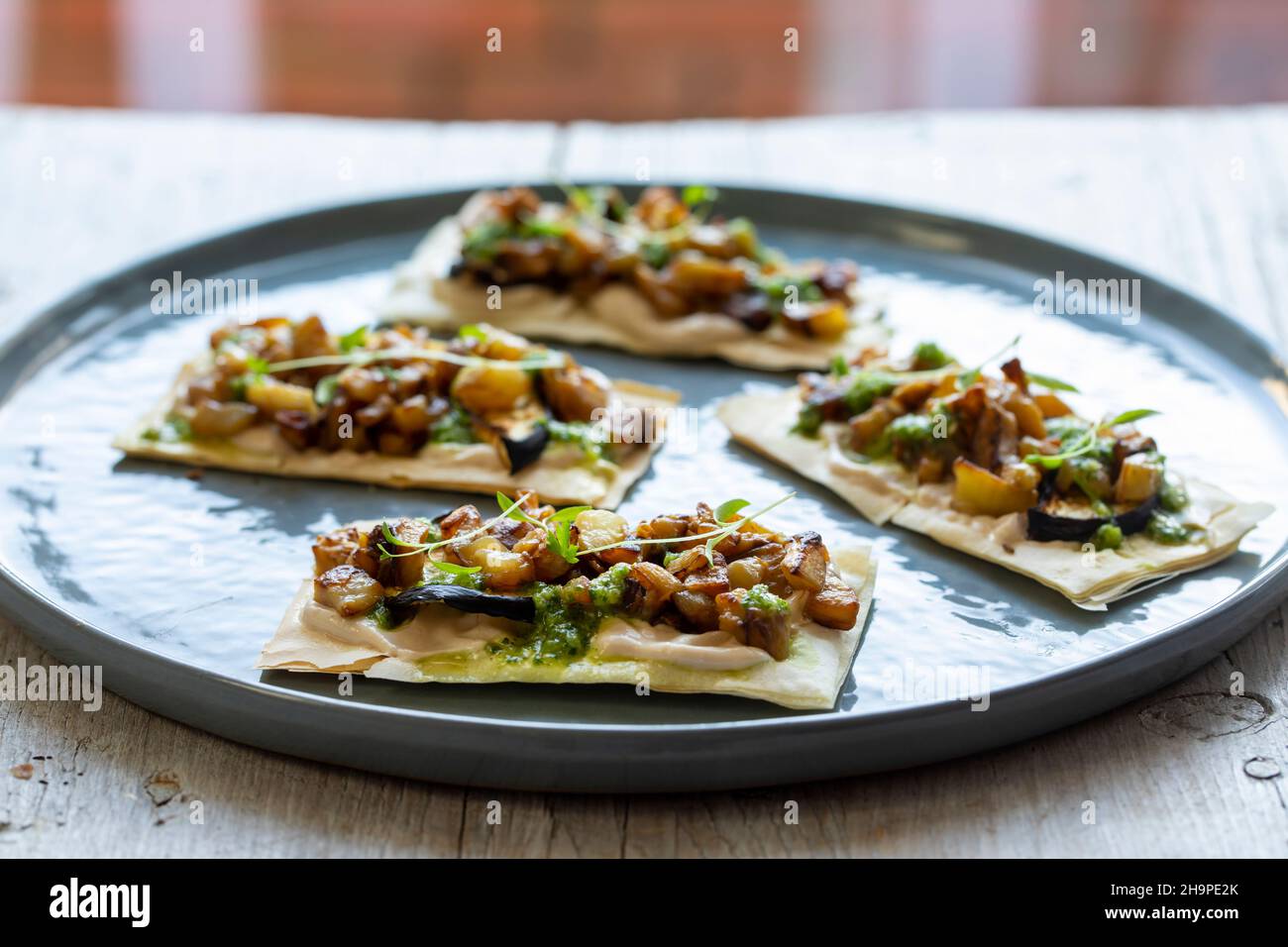 Vegan filo pastry canapes with aubergine and coriander sauce Stock ...