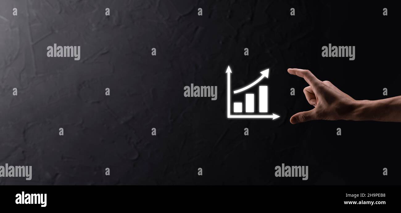 Businessman man holding a graph with positive profits growth. plan ...