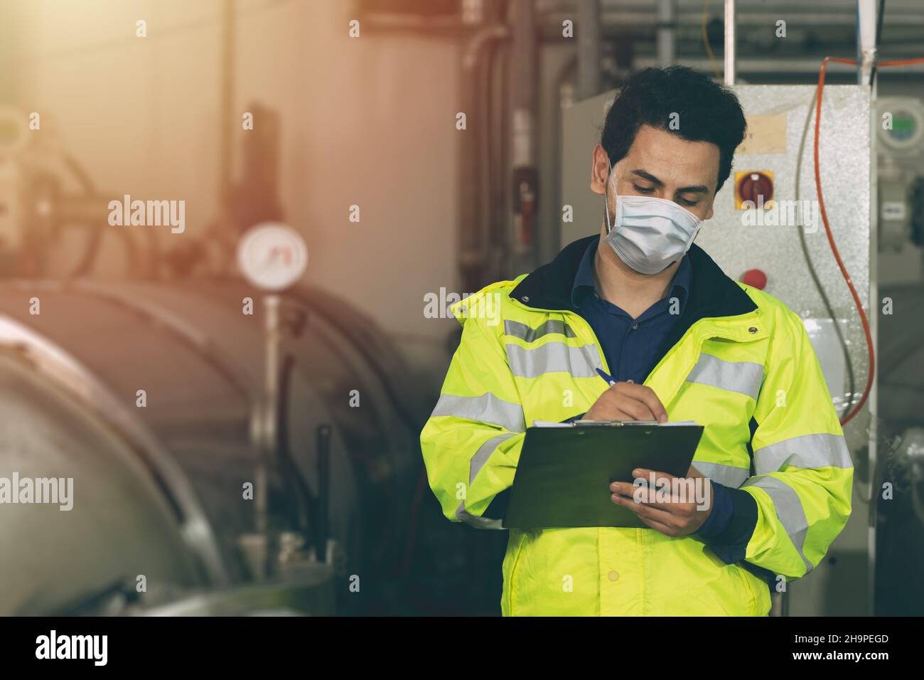 Worker wearing face shield or disposable face mask during working ...