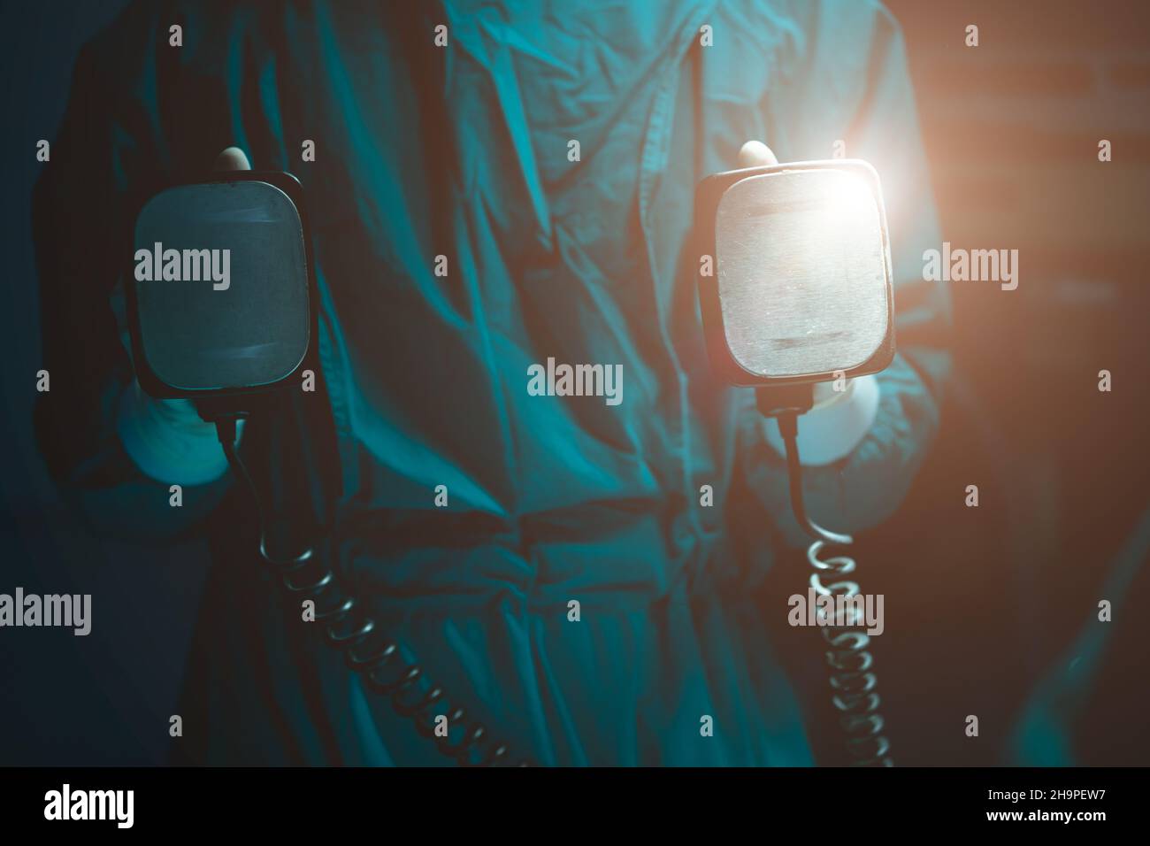 Doctor holding manual Defibrillator for Pulse generator in operating ...