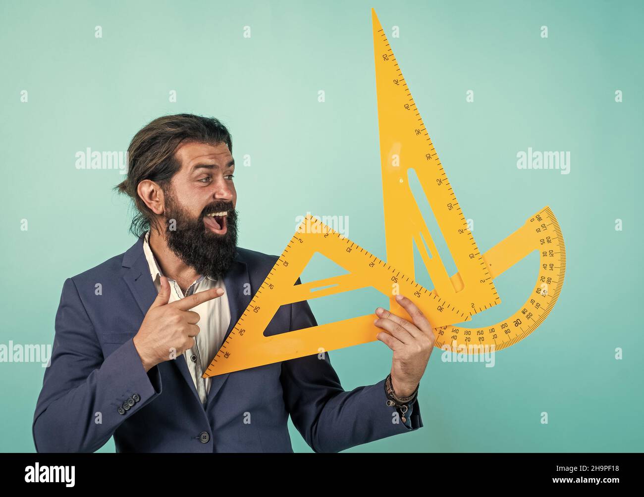 measure and size. happy mature teacher holding triangle and protractor ...