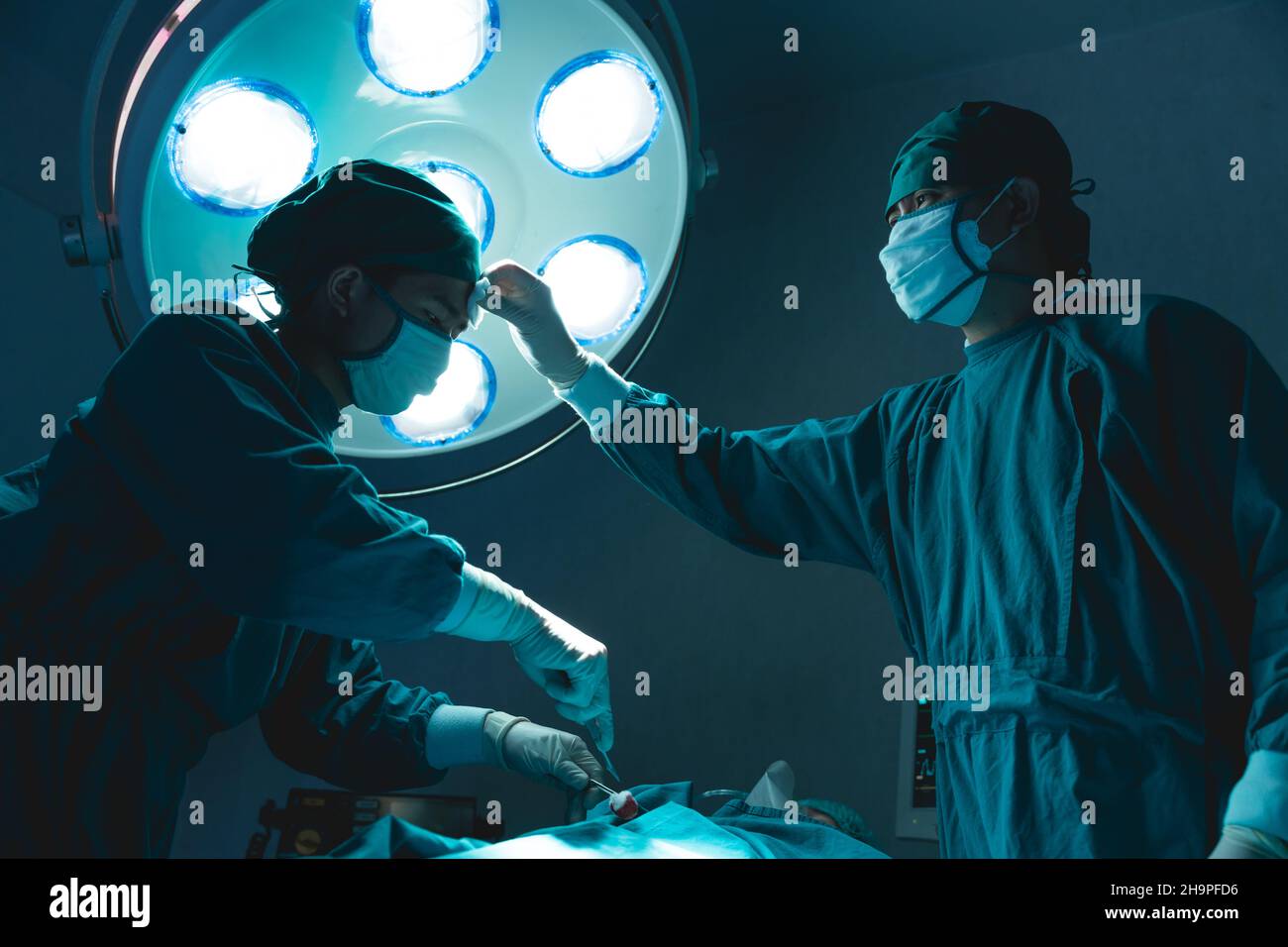 doctor team hard working in operating room attempt to save patient life ...