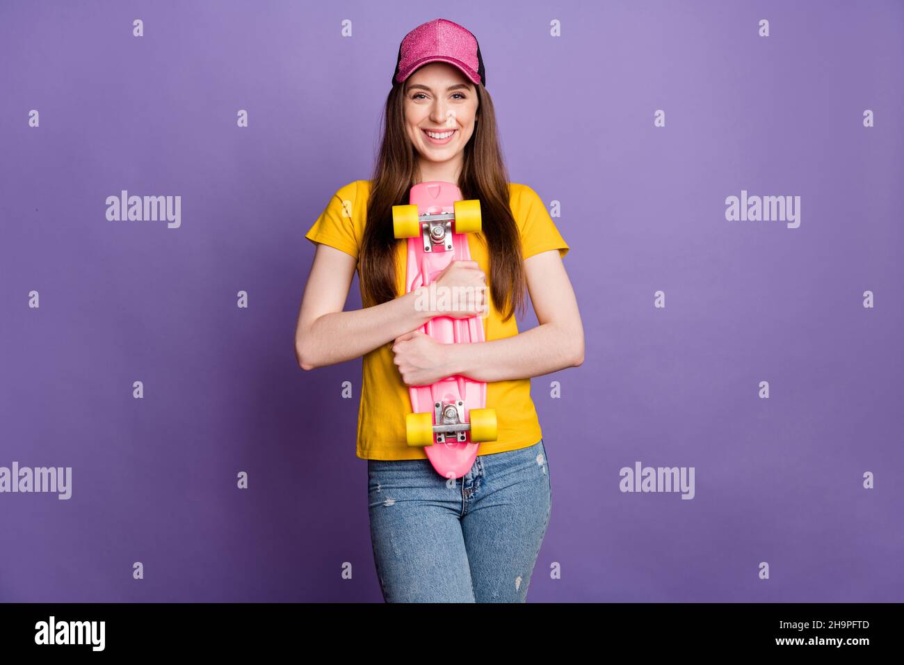 Photo of pretty young nice woman hold hands hug longboard smile ...