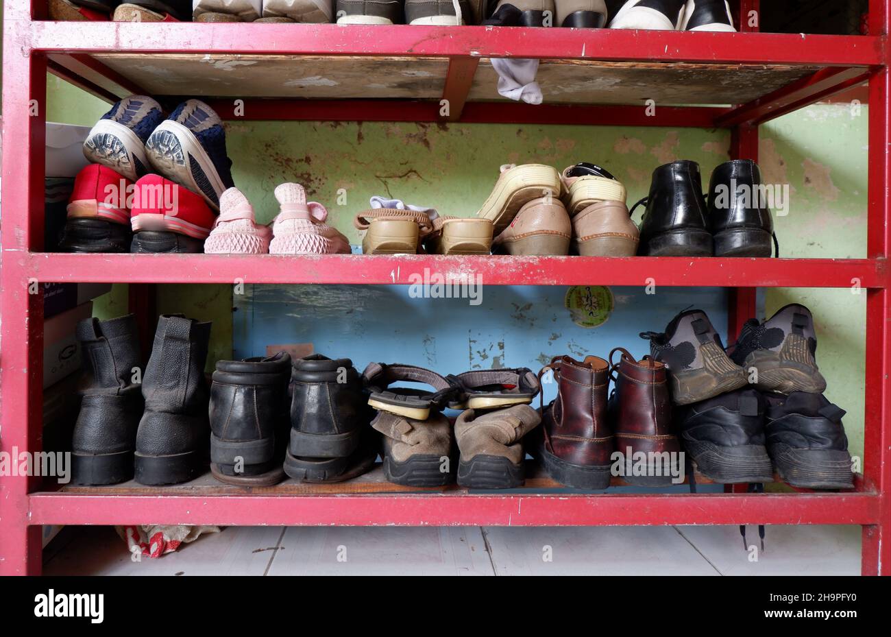 shoe rack made of iron. collection of shoes and sandals Stock Photo - Alamy
