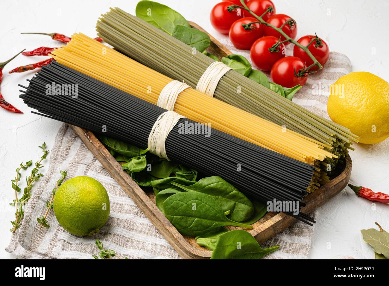 Multi colored pasta, on white stone table background Stock Photo - Alamy