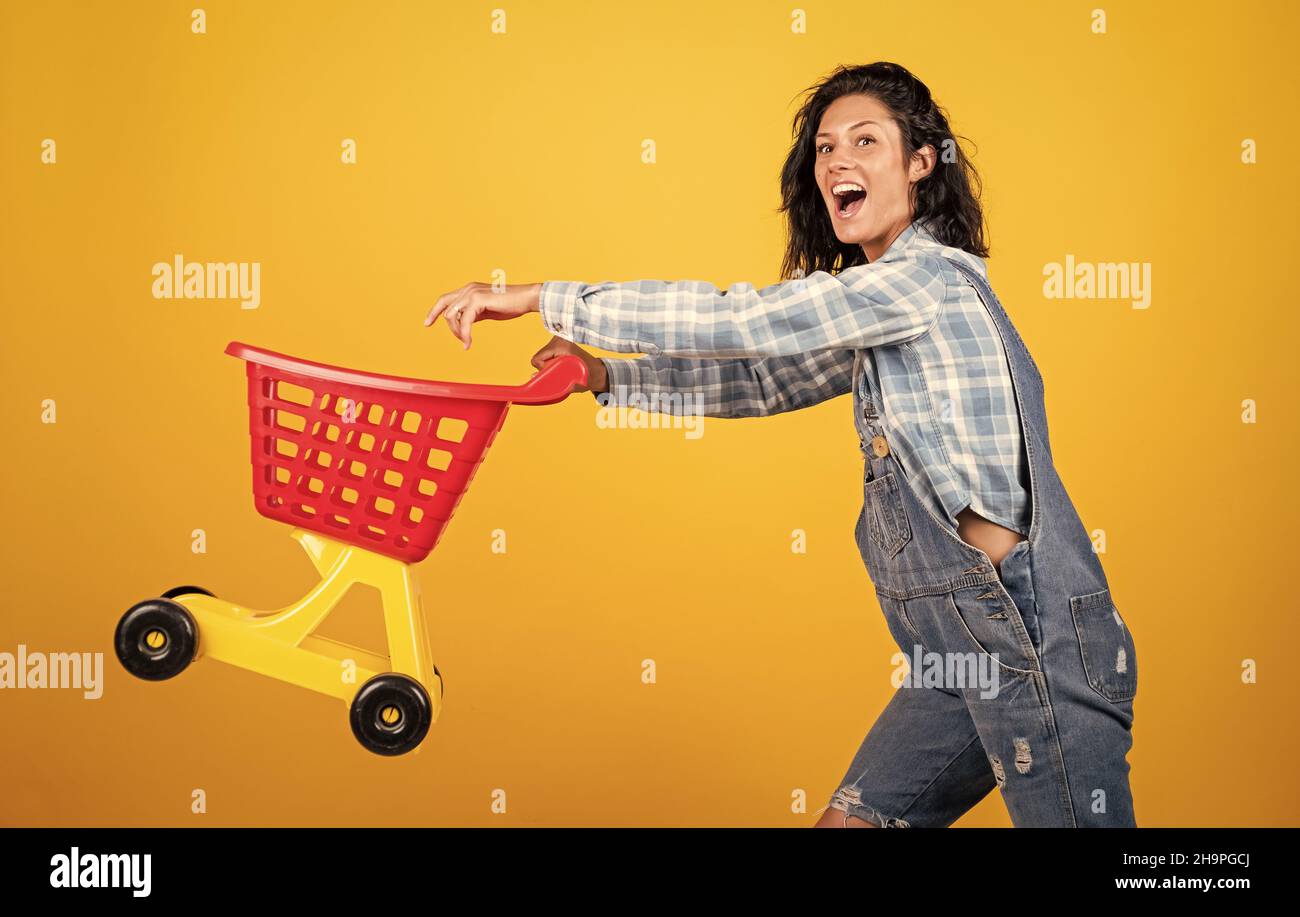prepare for holidays. happy beautiful lady carry shopping trolley. time ...