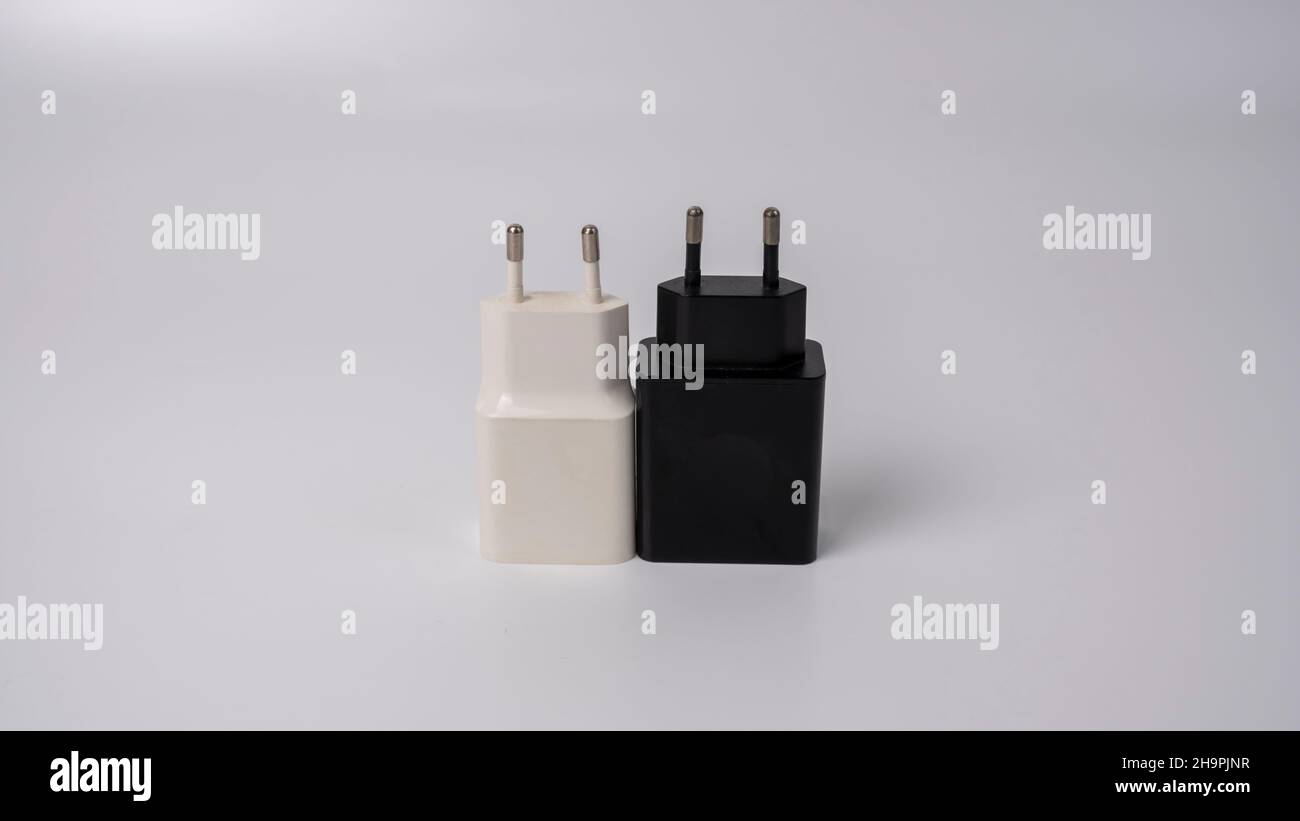 This is a black and white smartphone charger on a white background. It ...